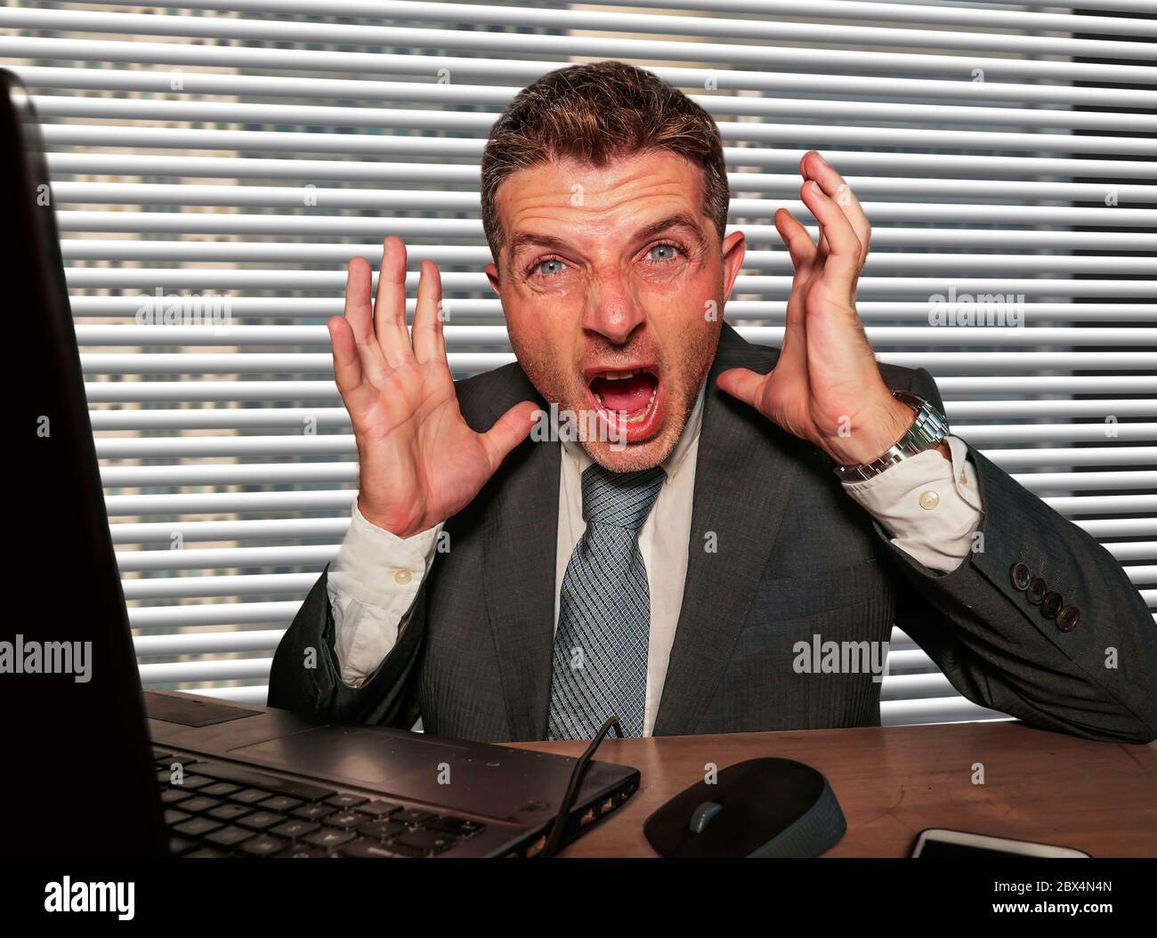 young stressed and overwhelmed businessman in suit and necktie ...