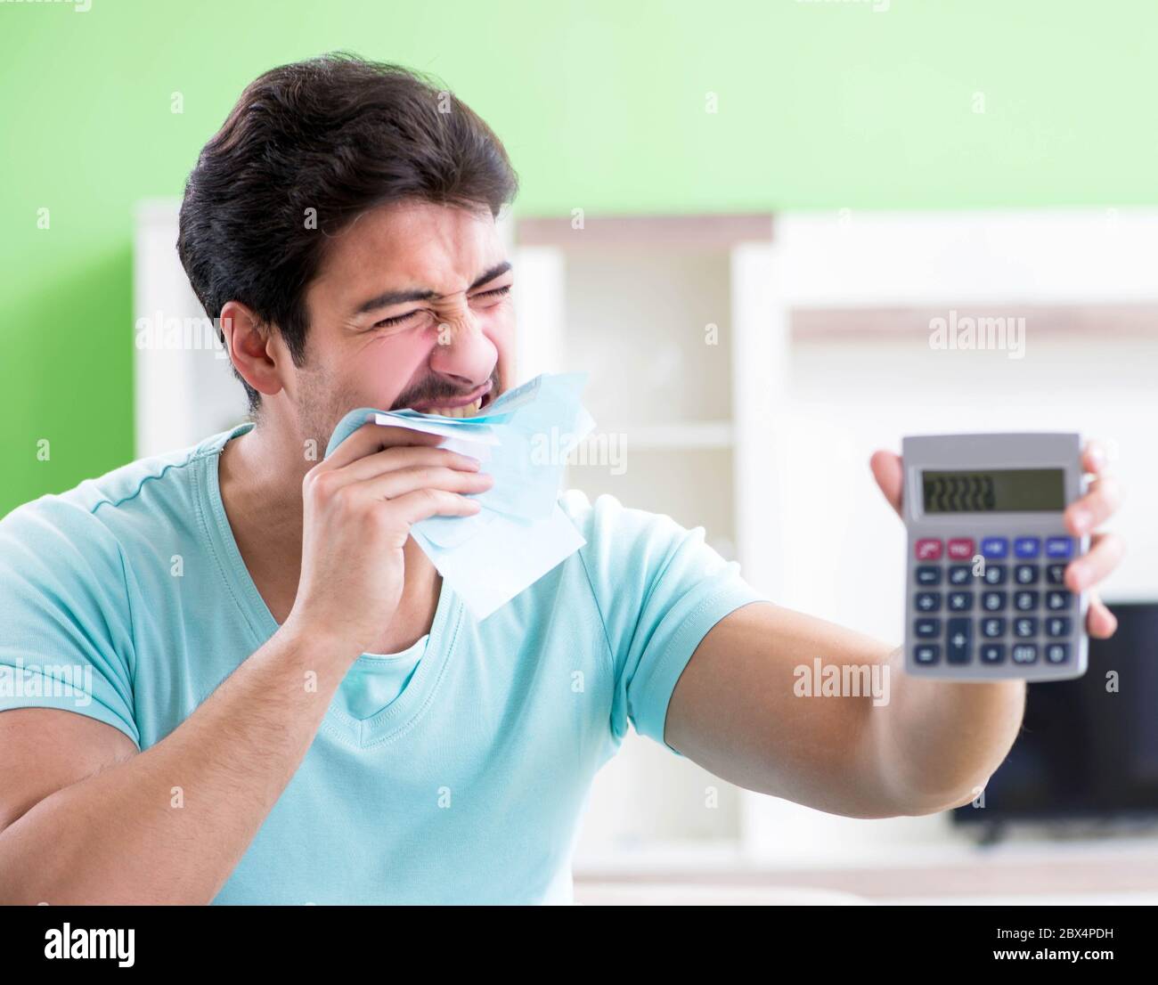 The young man struggling with personal finance and bills Stock Photo ...