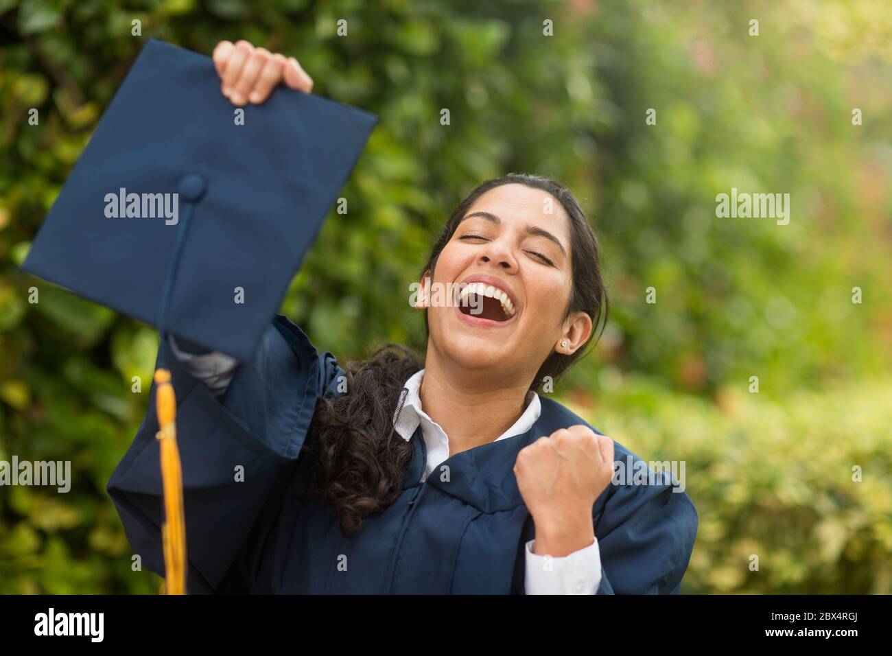 Young hispanic female graduate at her graduation Stock Photo - Alamy