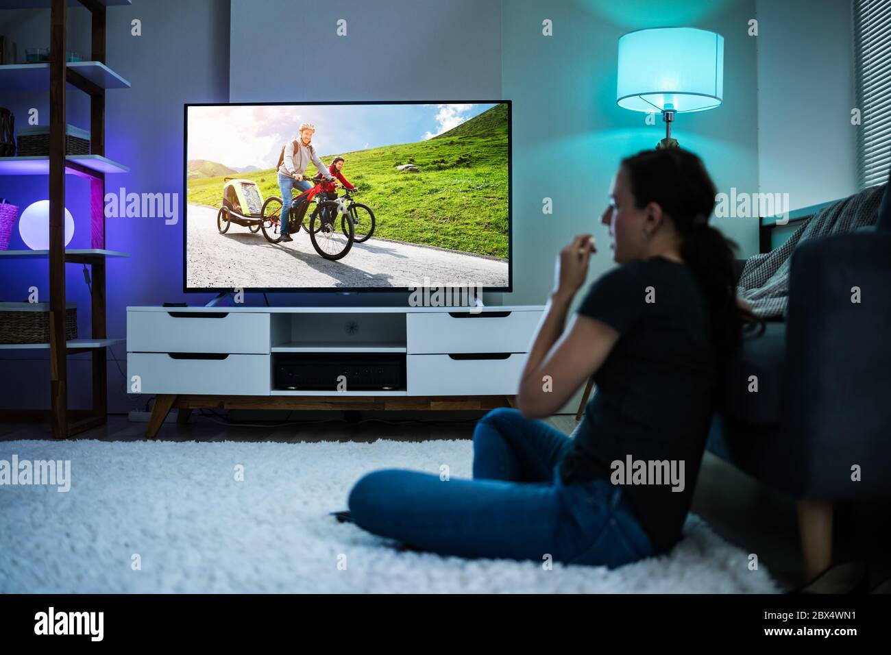 Woman Watching TV On Couch Or Sofa. Watch Television Stock Photo - Alamy