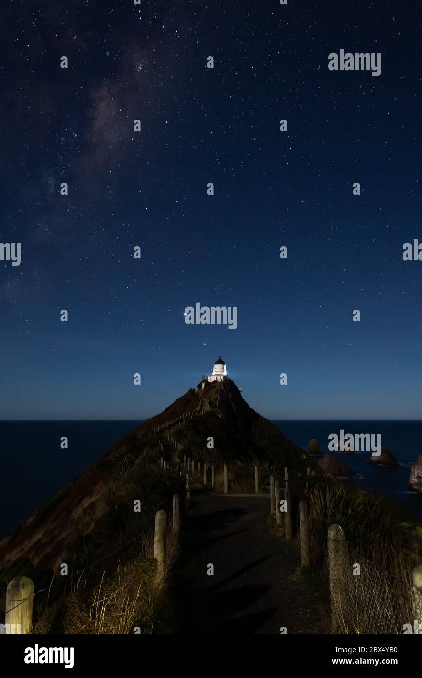 Starry night at Nugget Point Lighthouse, New Zealand, under the Milky ...