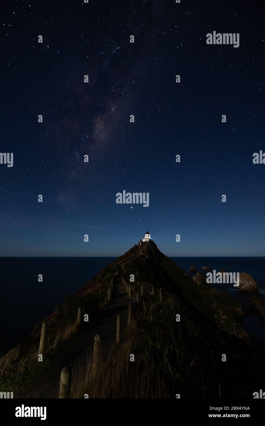Starry night at Nugget Point Lighthouse, New Zealand, under the Milky ...