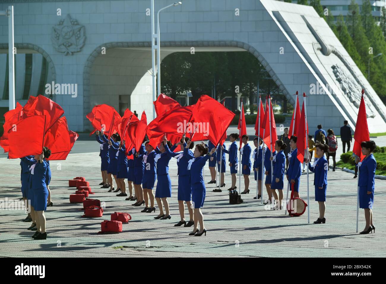 Pyongyang, North Korea - May 2, 2019: Girls with red flags perform ...