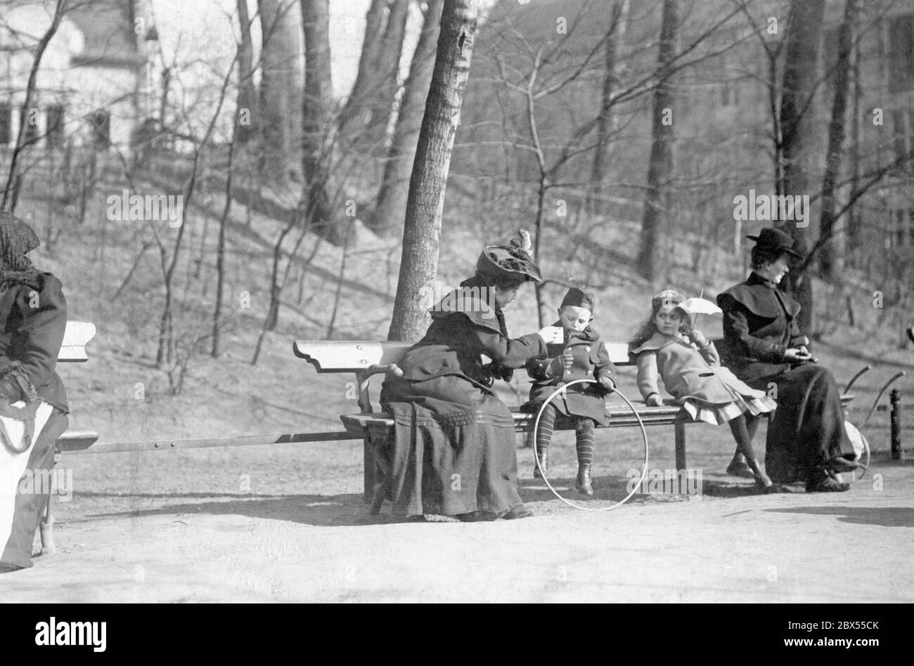 Children from the upper class in a city park in Berlin together with ...