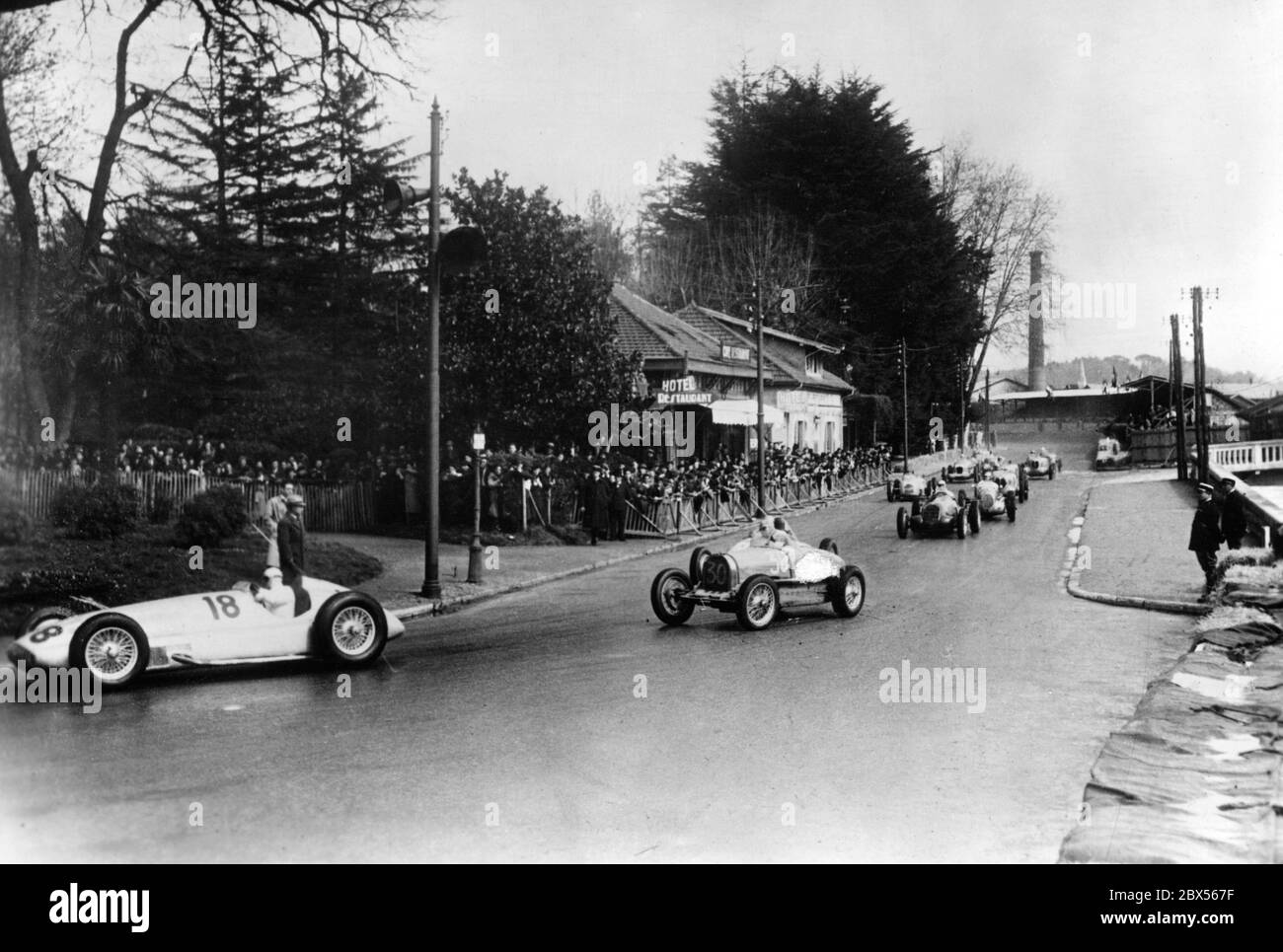 Racing driver Hermann Lang (in front) leads the field and wins the ...