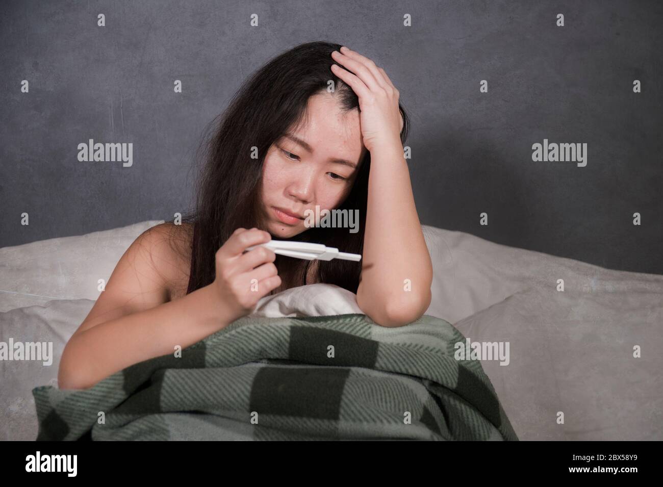 young depressed and desperate Asian Chinese woman crying and scared ...