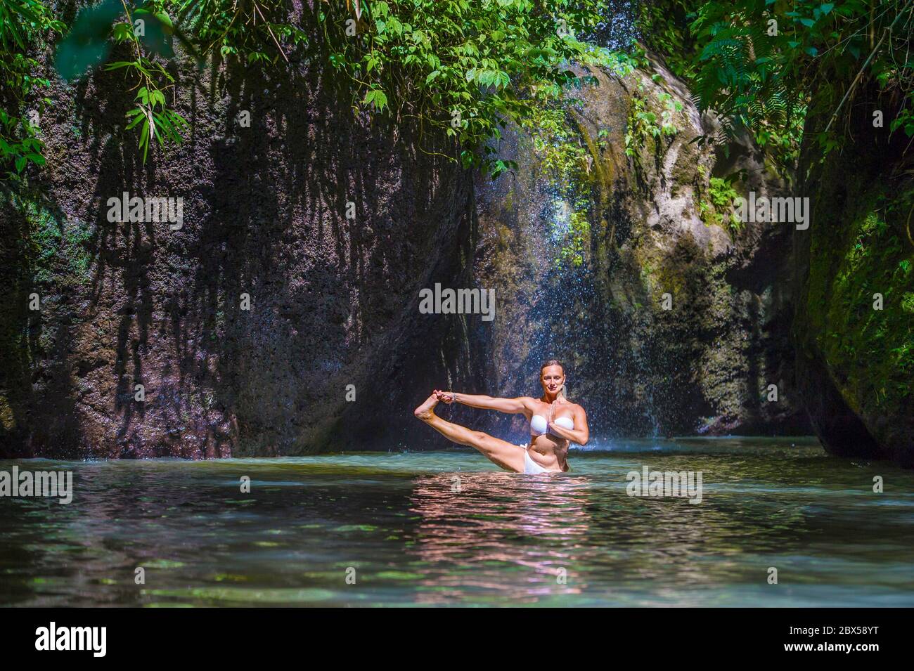 attractive and fit tourist Caucasian woman practicing yoga exercise ...
