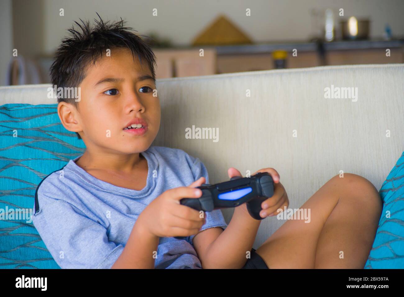 lifestyle portrait of Latin young child 8 years old excited and happy ...