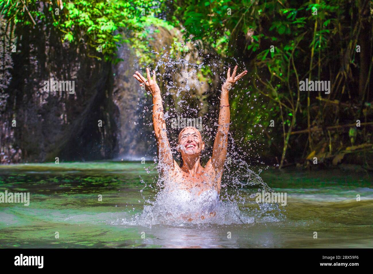 Girl playing in waterfall hi-res stock photography and images - Alamy