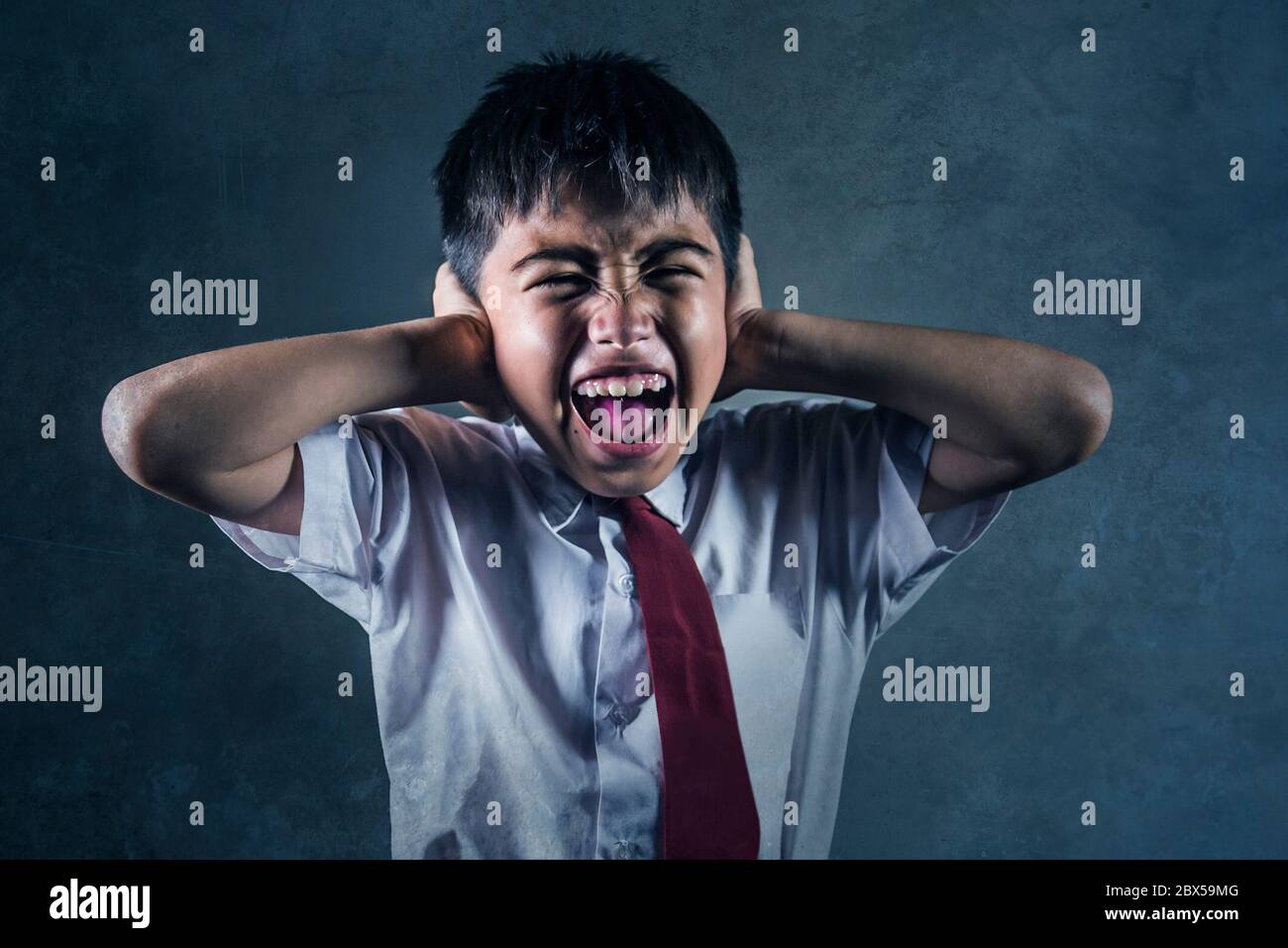 dramatic portrait of young desperate and abused schoolboy screaming and ...