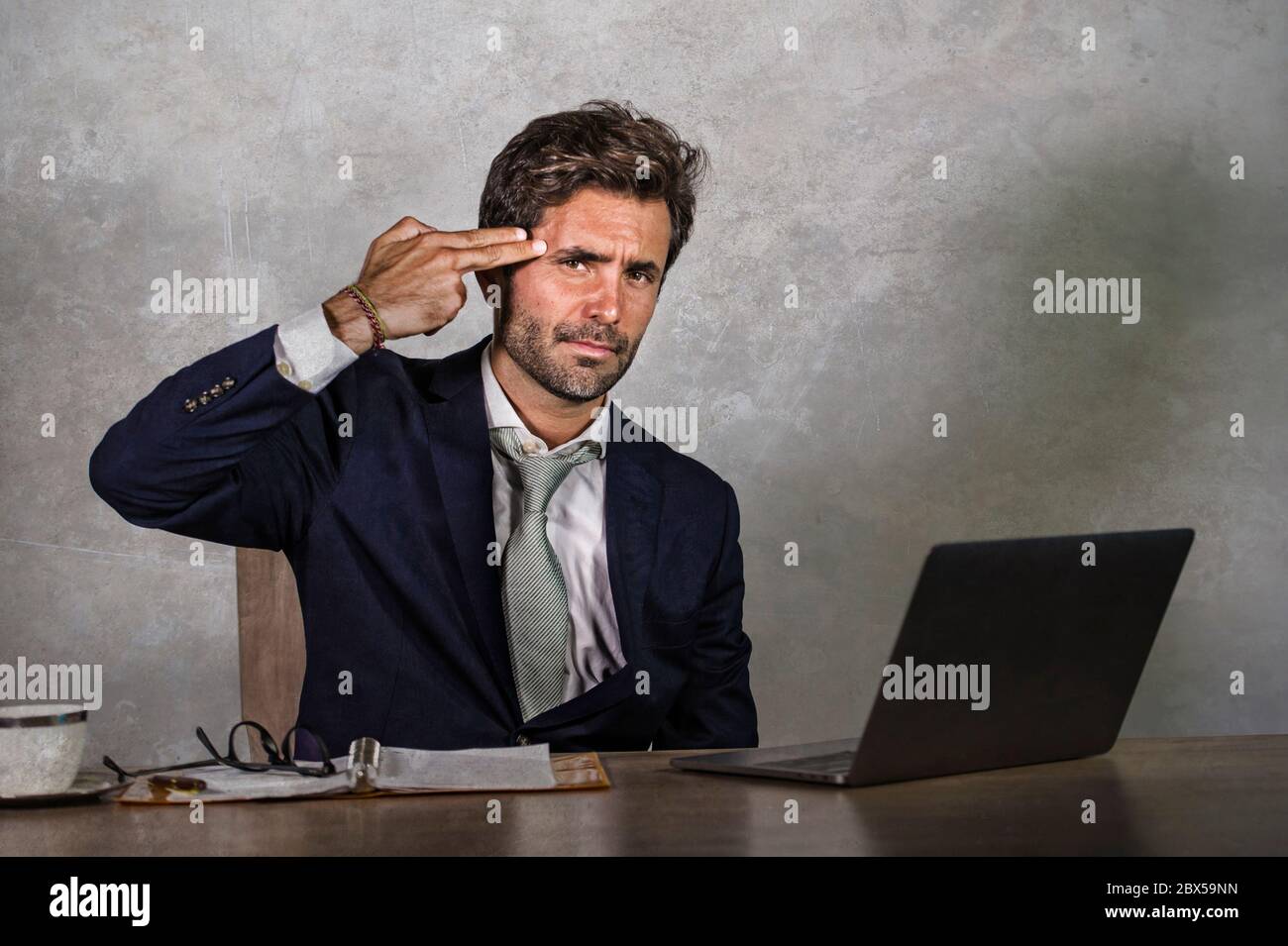 young sad and depressed business man working overwhelmed and frustrated ...