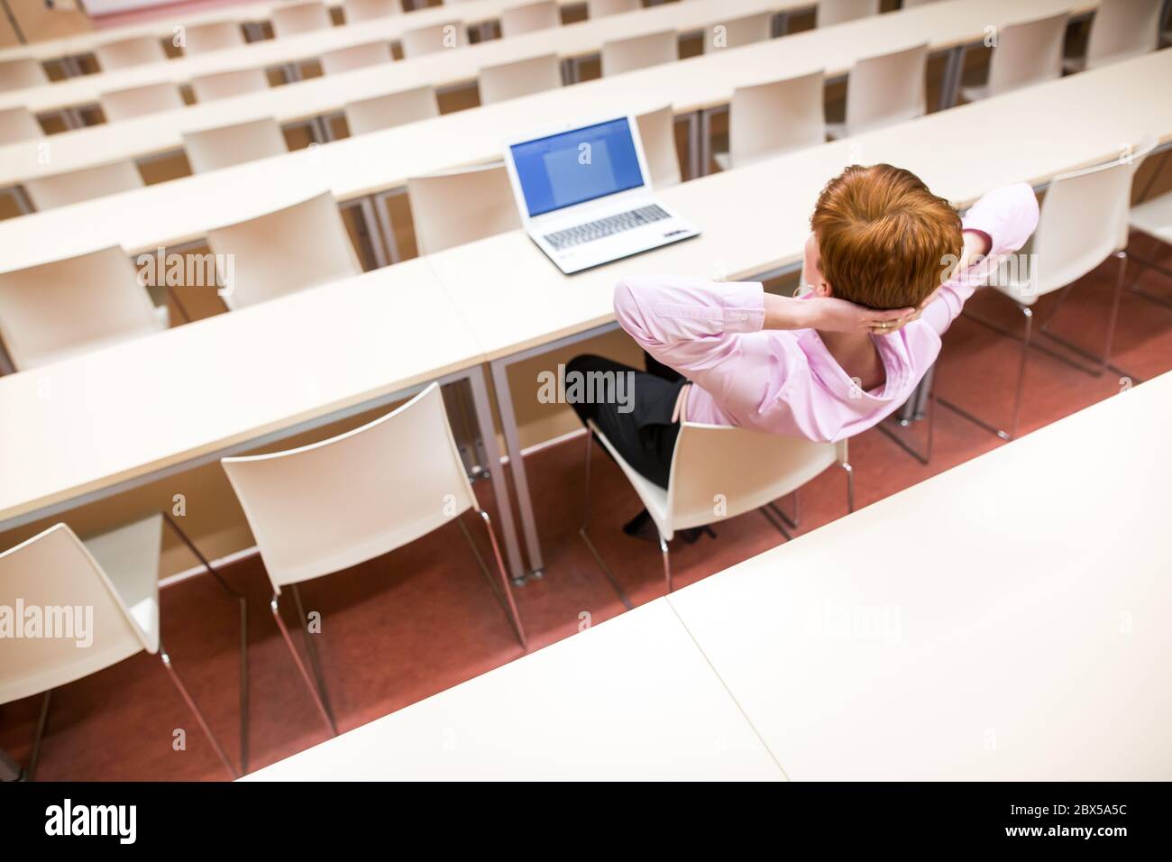 Pretty young college student with notebook, laptop studying in modern ...