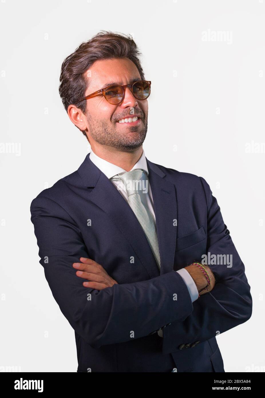 young elegant and handsome happy man in suit posing for company ...