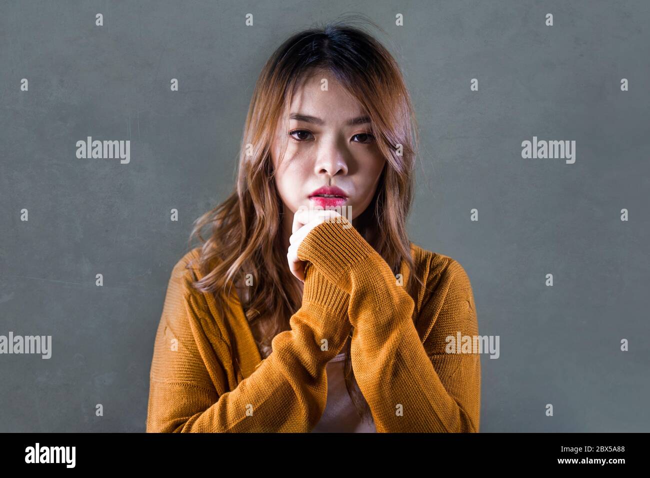 young crazy desperate and sad Asian Korean woman looking depressed and ...