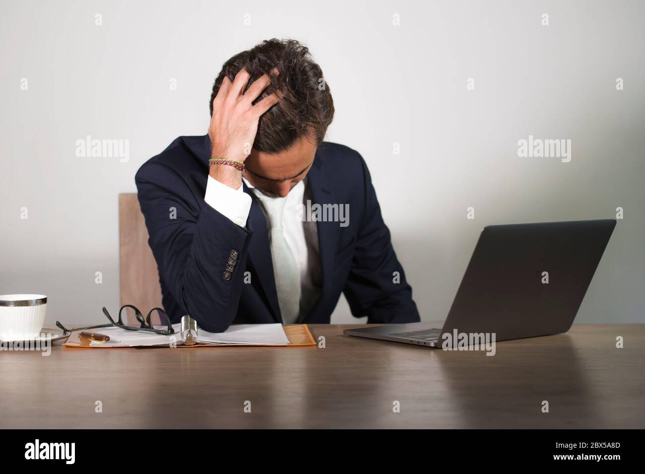 young sad and depressed business man working overwhelmed and frustrated ...