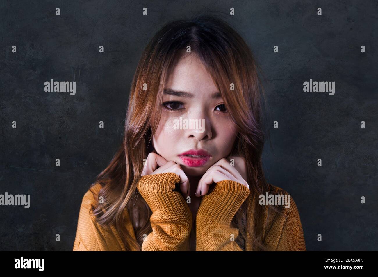 young crazy desperate and sad Asian Korean woman looking depressed and ...