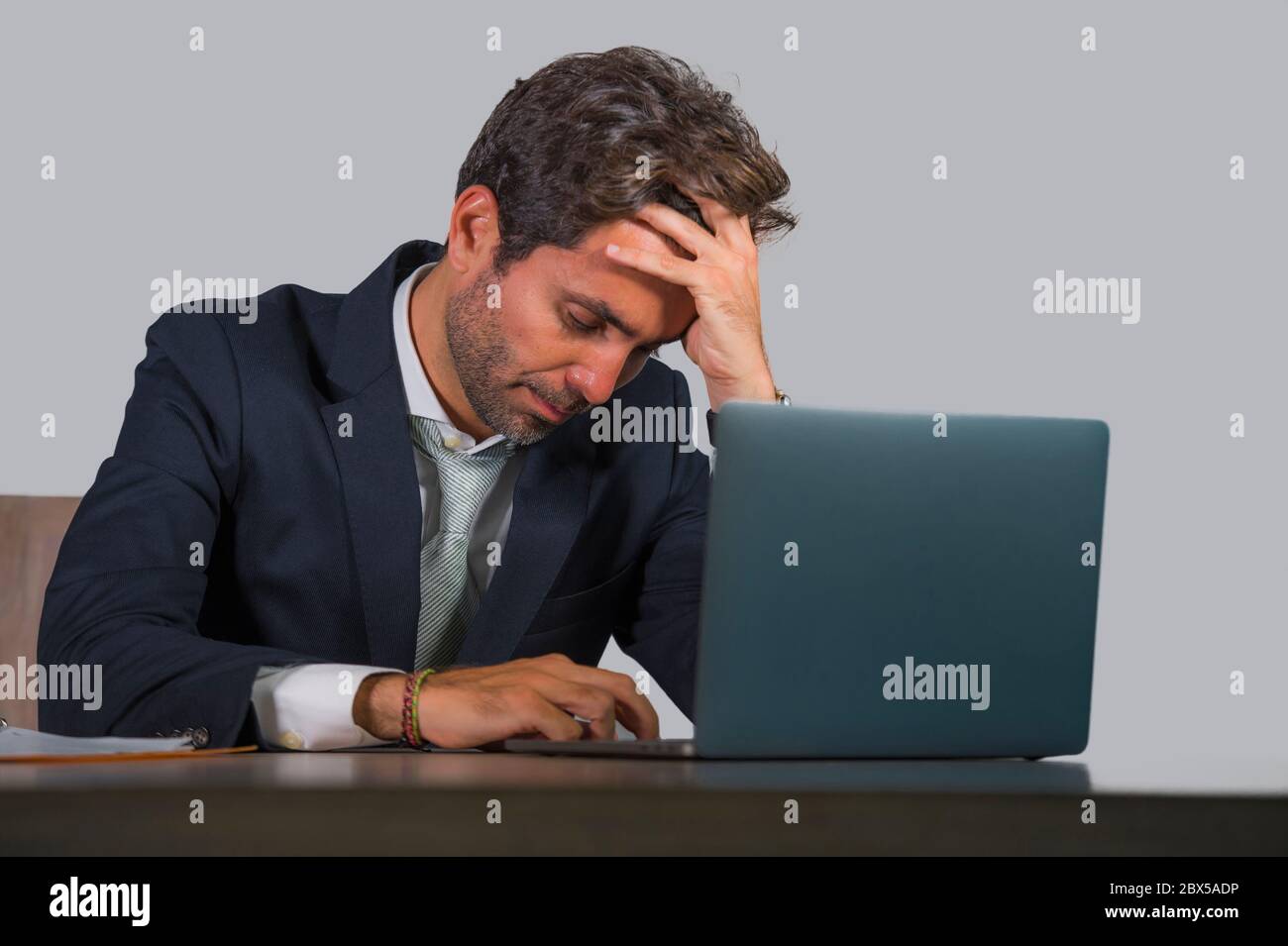 young sad and depressed business man working overwhelmed and frustrated ...