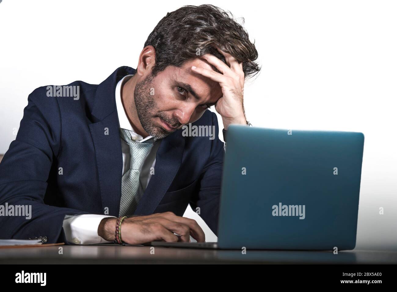 young sad and depressed business man working overwhelmed and frustrated ...