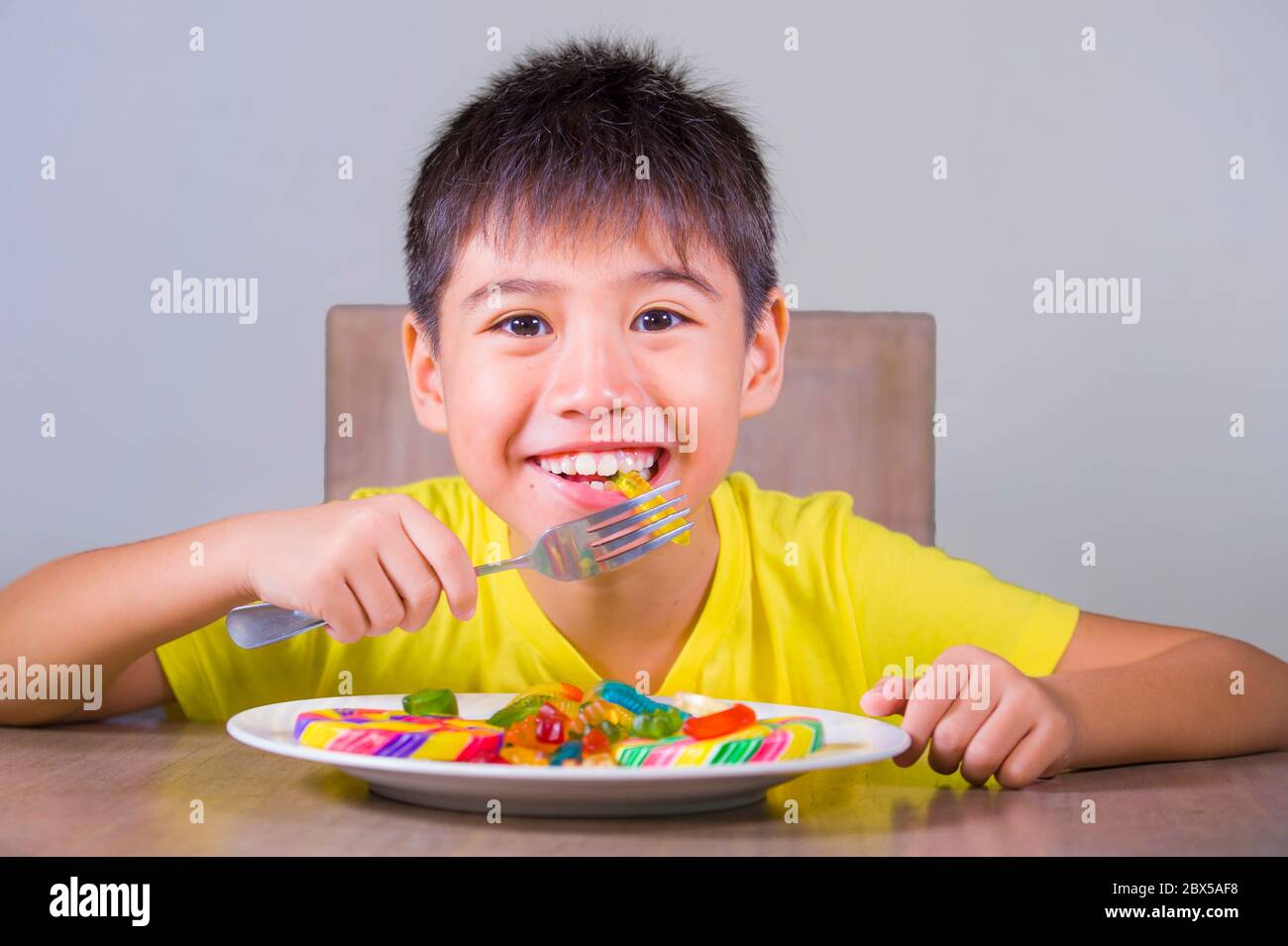 young happy and excited male kid smiling cheerful eating dish full of ...