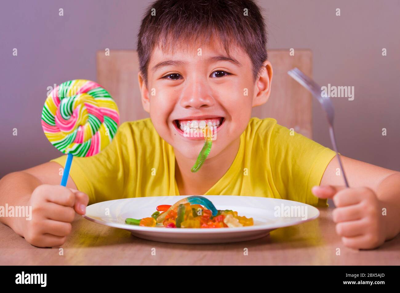 young happy and excited male kid smiling cheerful eating dish full of ...