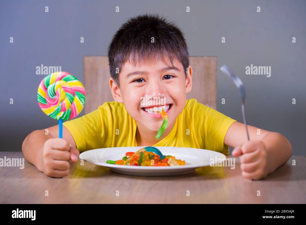 young happy and excited male kid smiling cheerful eating dish full of ...