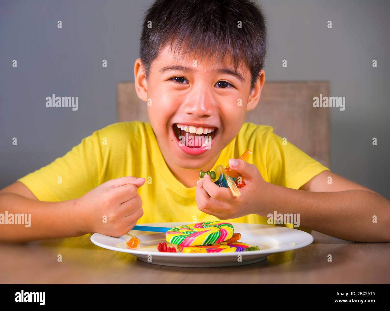 young happy and excited male kid smiling cheerful eating dish full of ...
