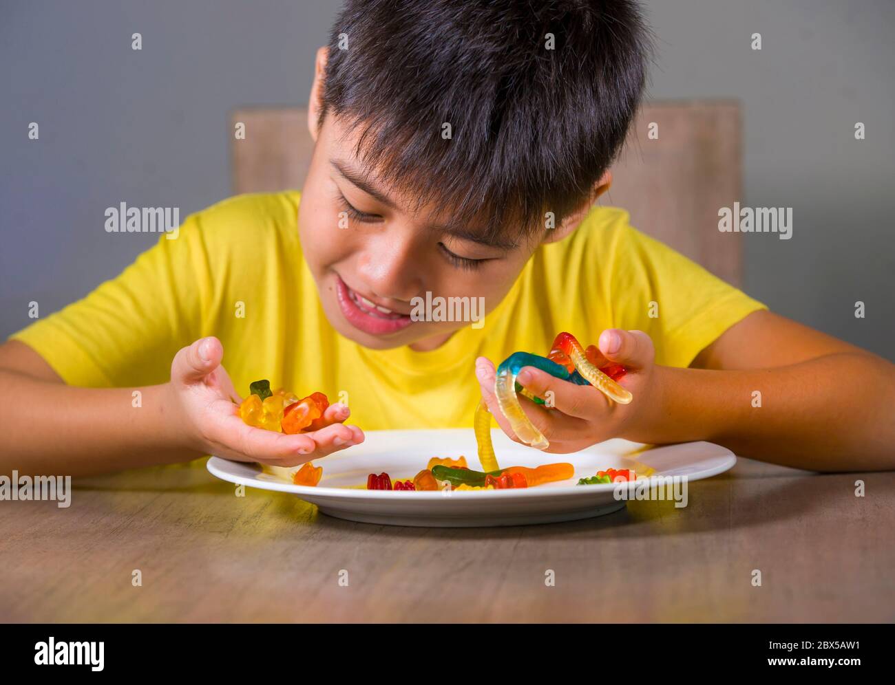young happy and excited male kid smiling cheerful eating dish full of ...