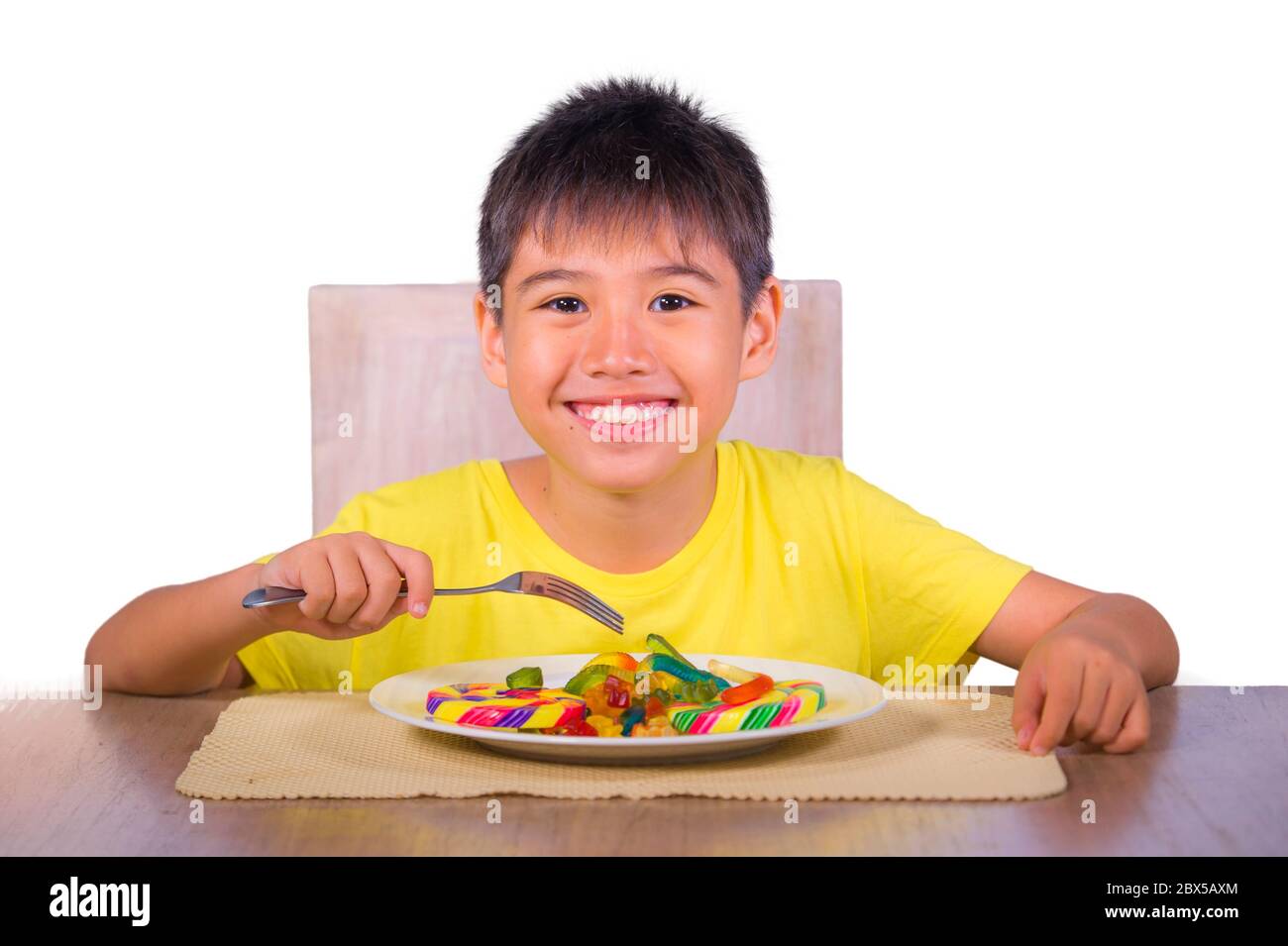young happy and excited male kid smiling cheerful eating dish full of ...