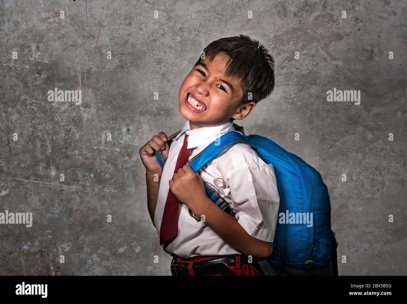 Child carrying heavy school bag hi-res stock photography and images - Alamy
