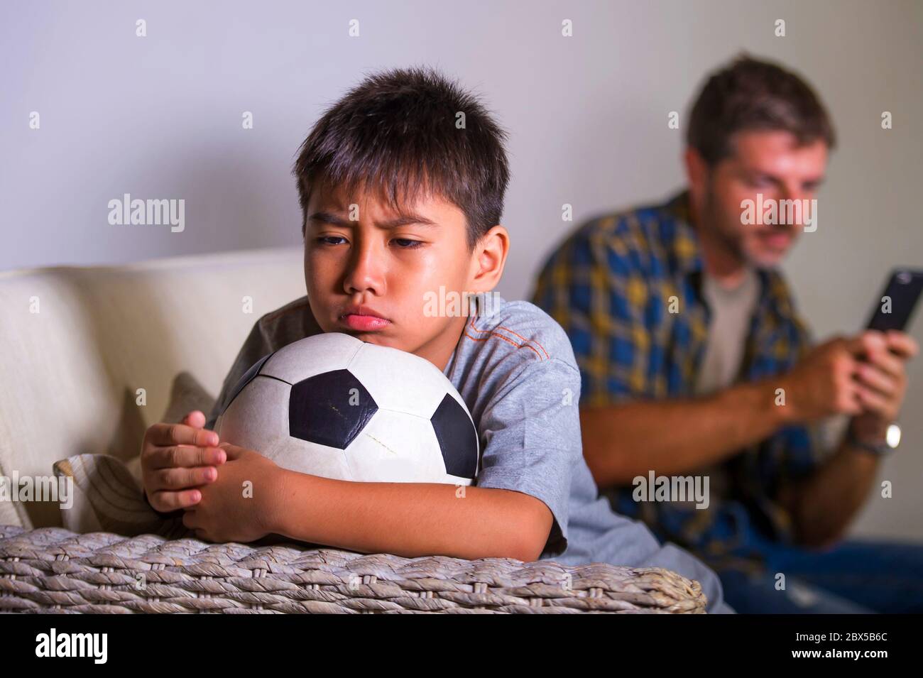 young sad and bored child at home couch feeling frustrated and ...