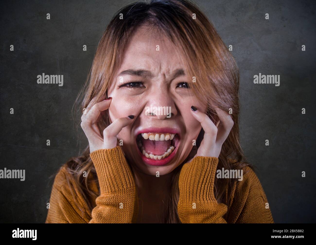 Young Crazy Desperate And Upset Asian Korean Woman Screaming Scared And