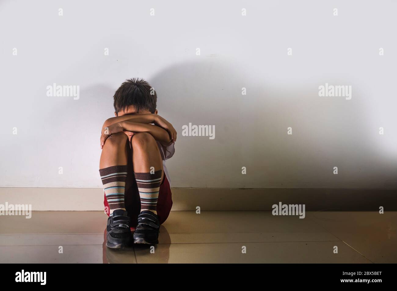 lifestyle dramatic bullying victim portrait of young sad and scared ...