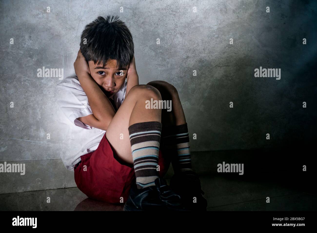 lifestyle dramatic bullying victim portrait of young sad and scared ...