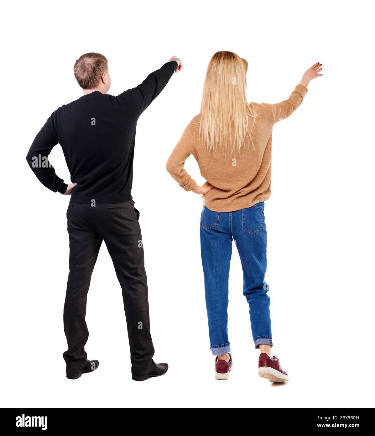 Back view of couple in sweater pointing. Rear view people collection ...