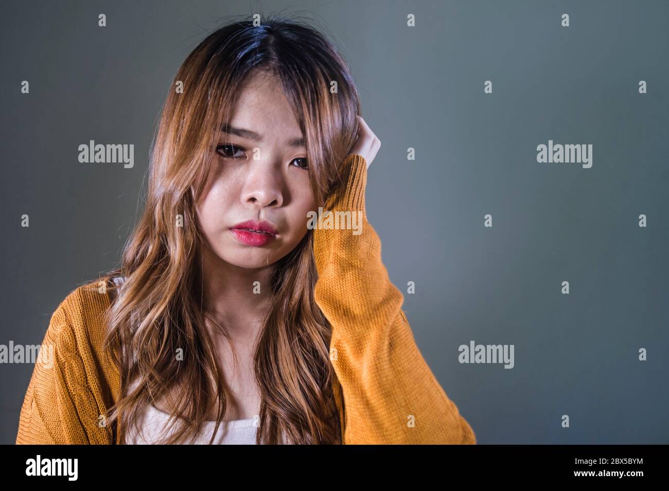 young crazy desperate and sad Asian Korean woman looking depressed and ...