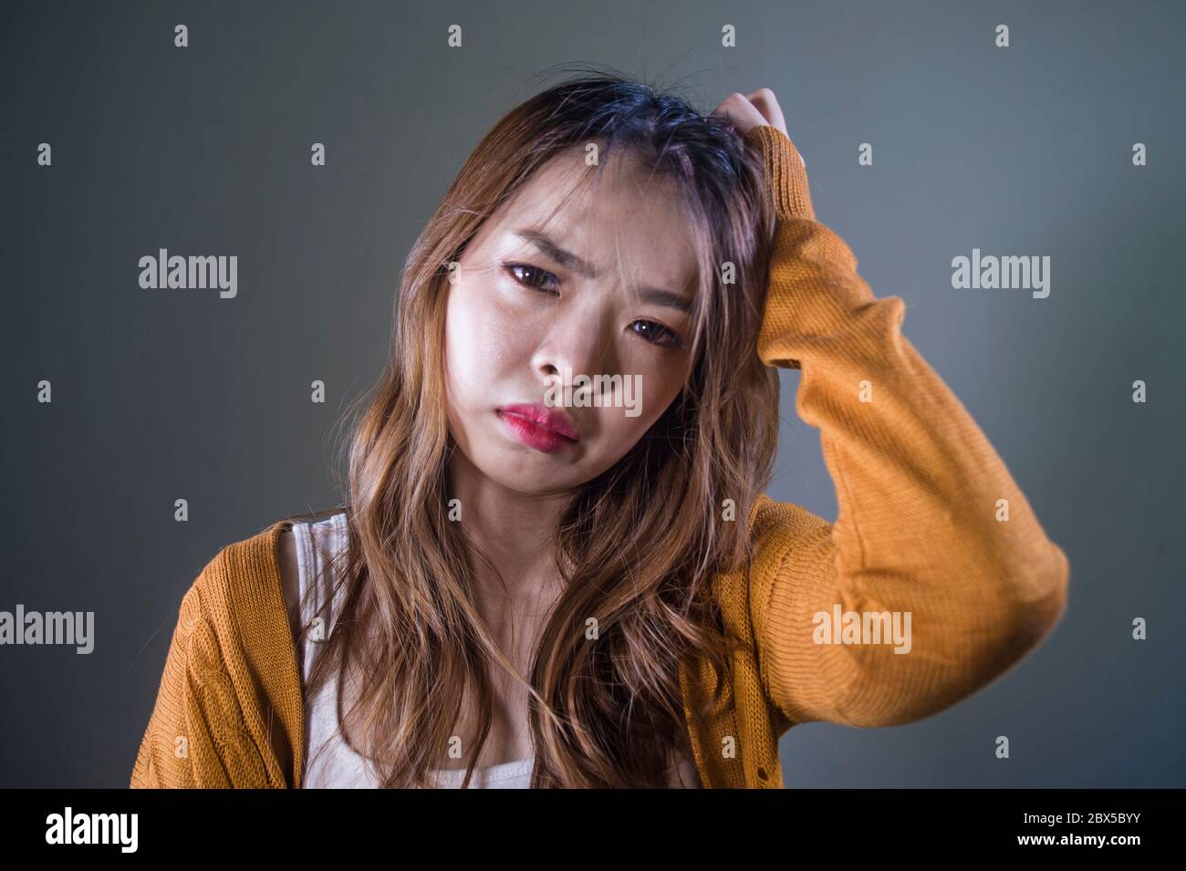 young crazy desperate and sad Asian Korean woman looking depressed and ...