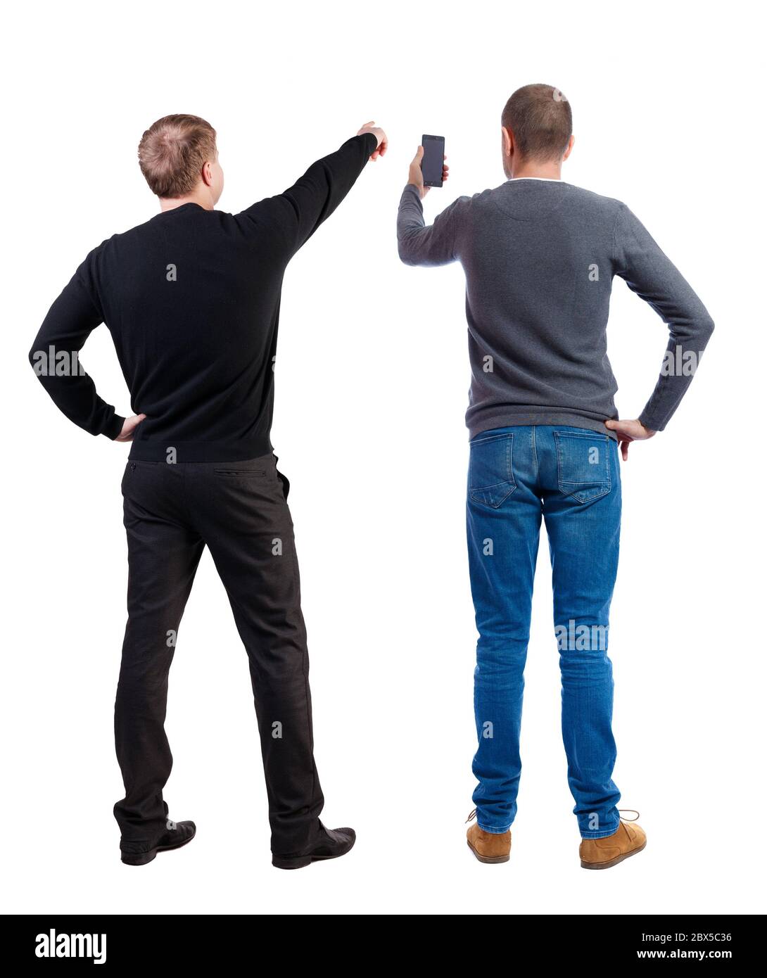 Back view of two man in sweater with mobile phone. Rear view people ...