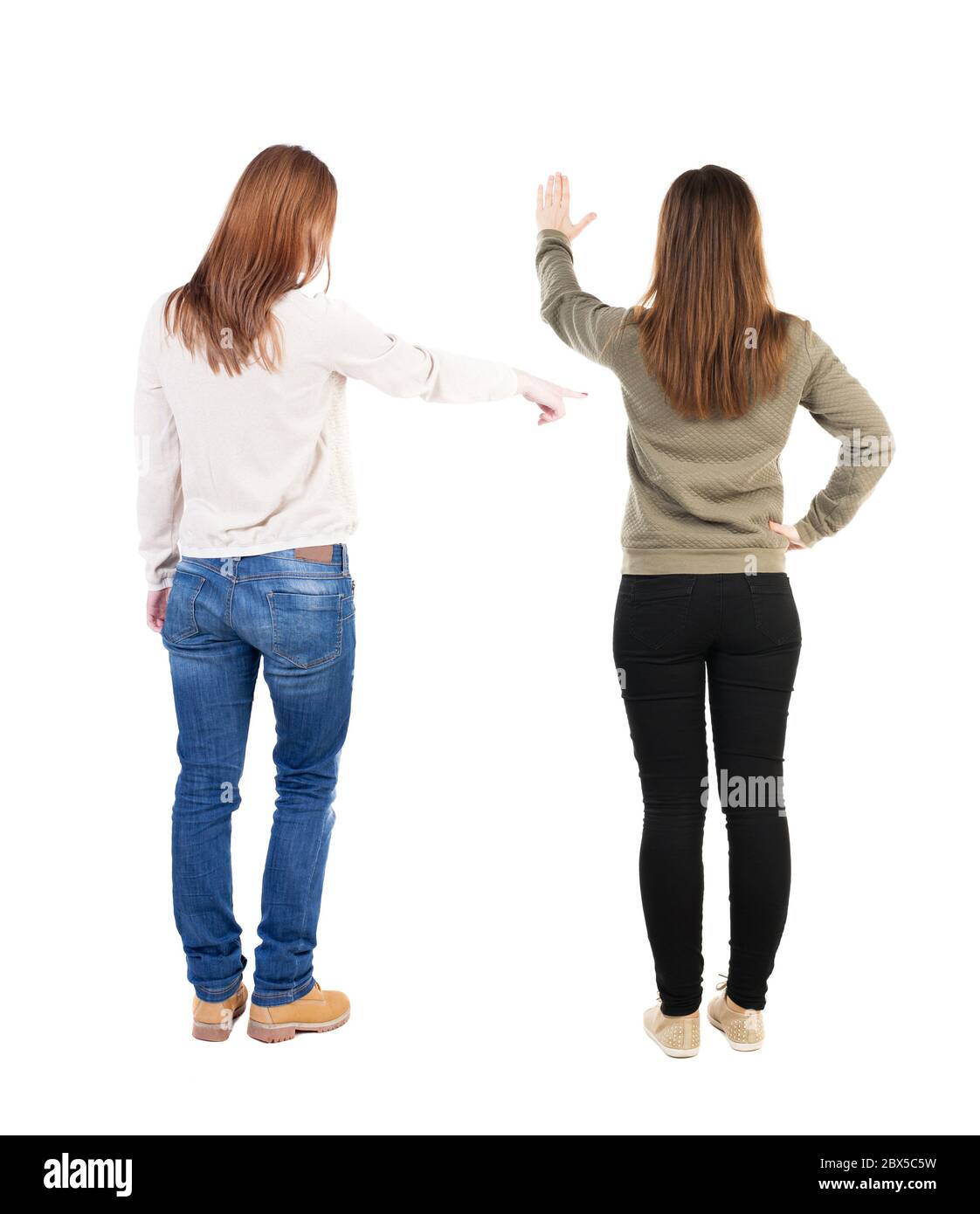 Back view of two pointing girl in sweater. Rear view people collection ...