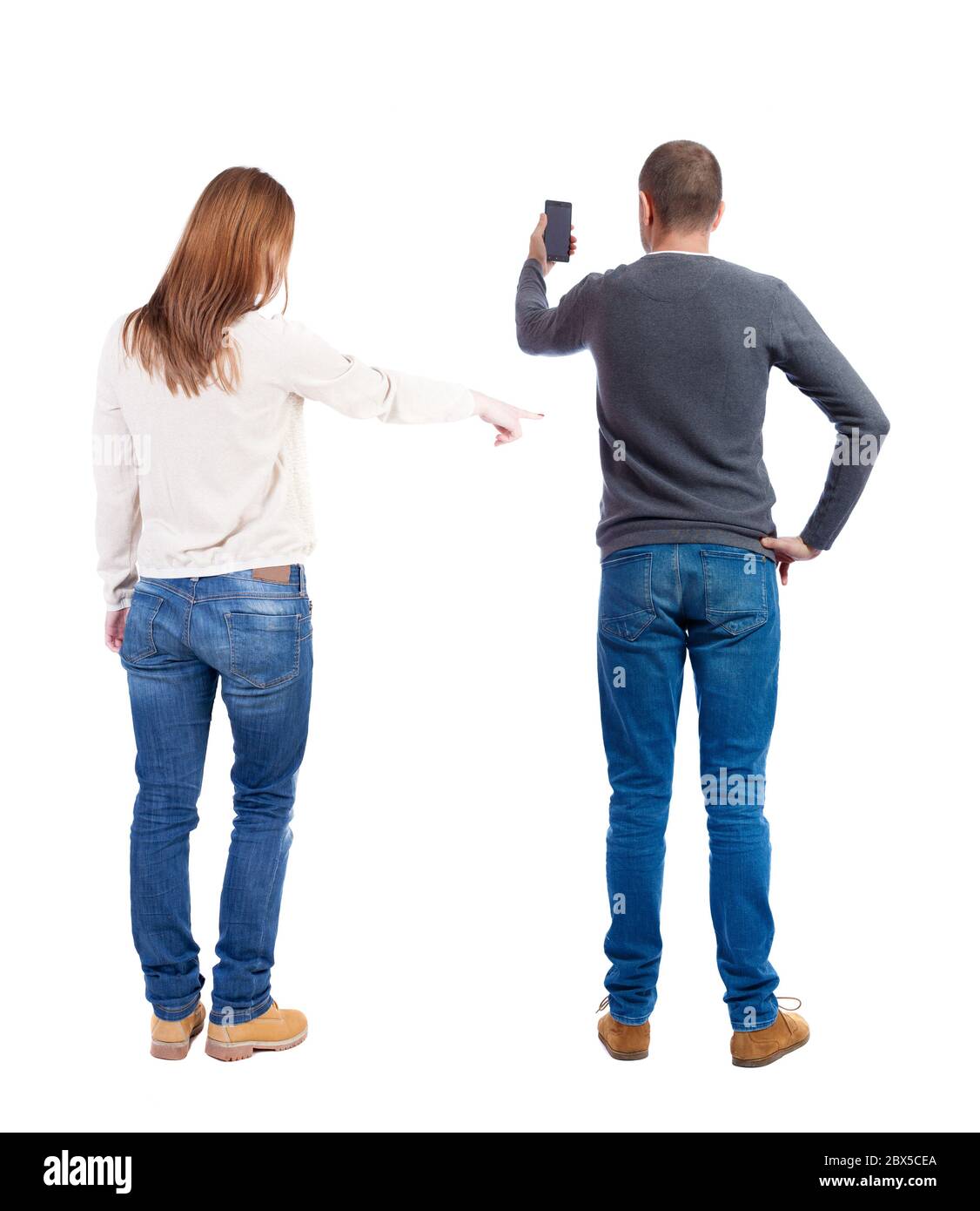 Back view of two man in sweater with mobile phone. Rear view people ...