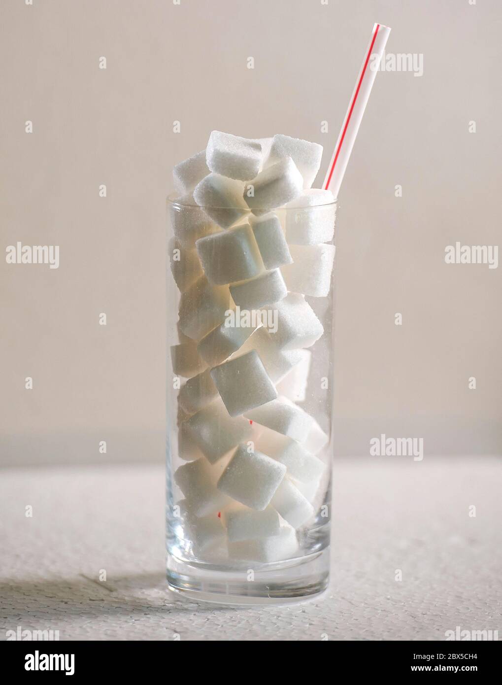 conceptual macro still life image of refreshment glass full of sugar ...