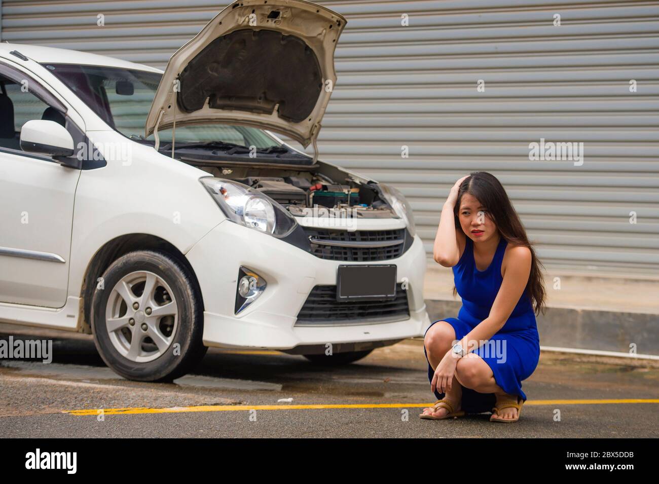 young desperate and worried Asian Korean woman in stress stranded on ...