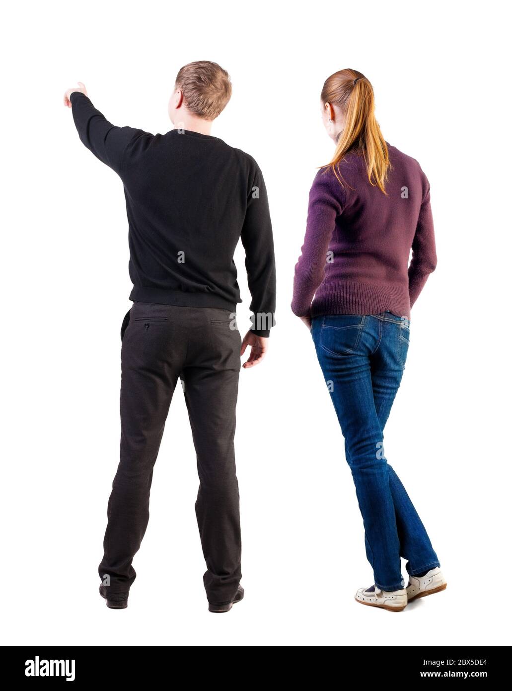Back view of couple in sweater pointing. Rear view people collection ...