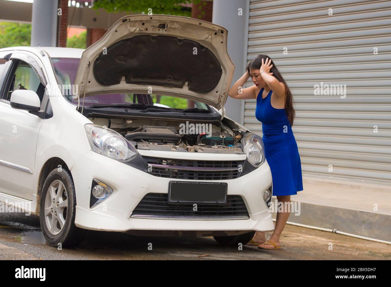young desperate and worried Asian Japanese woman in stress stranded on ...