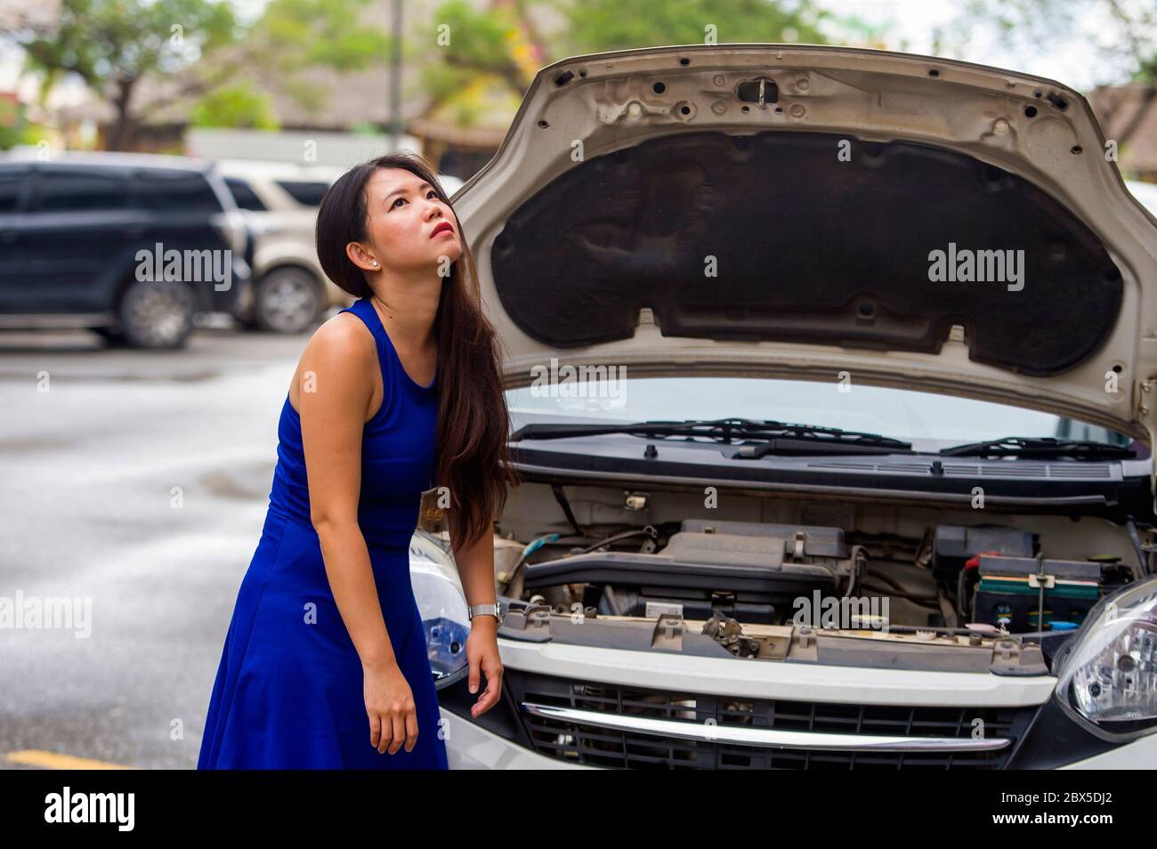 young desperate and worried Asian Japanese woman in stress stranded on ...