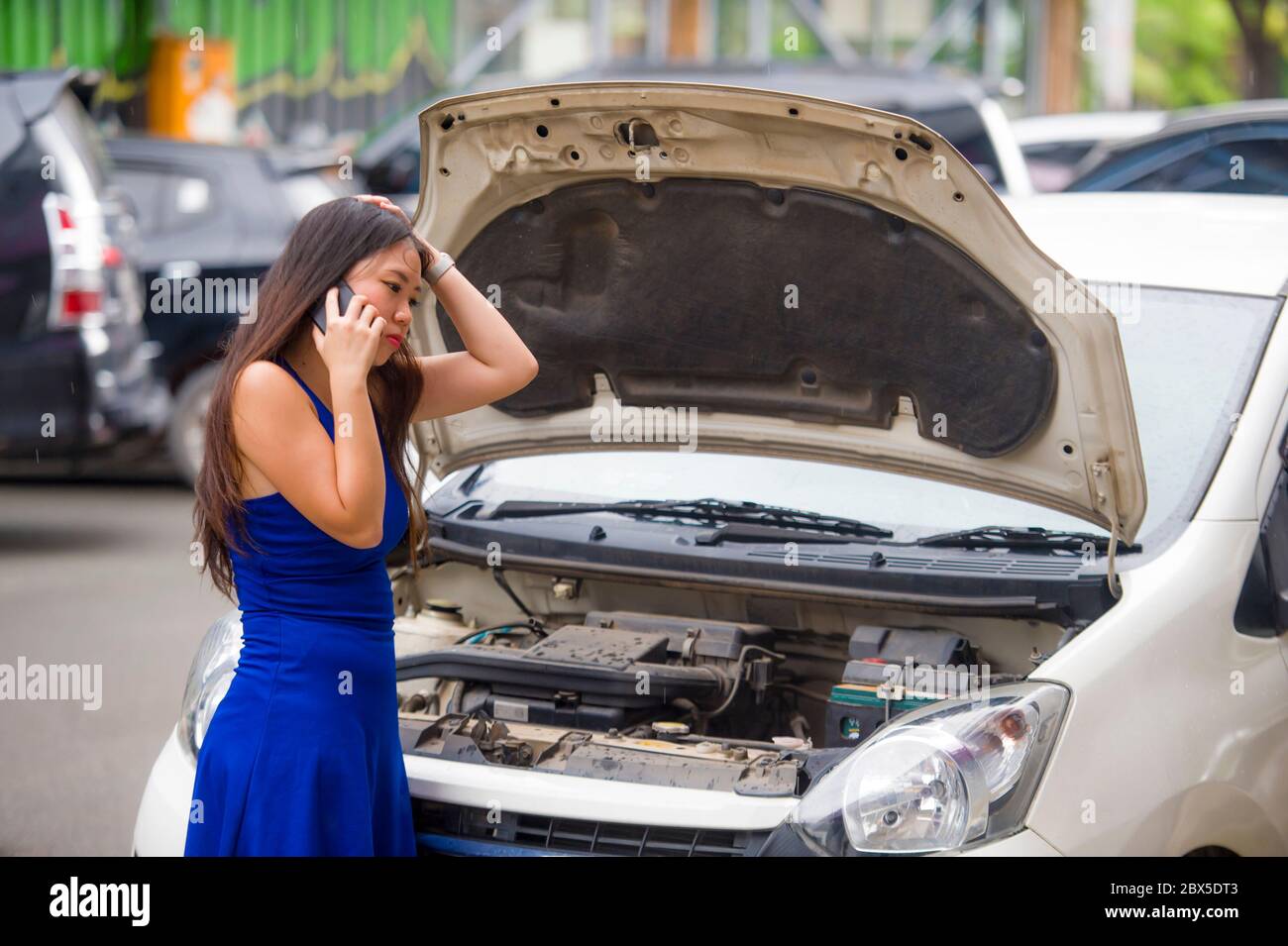 young desperate and upset Asian Korean woman in stress stranded on ...
