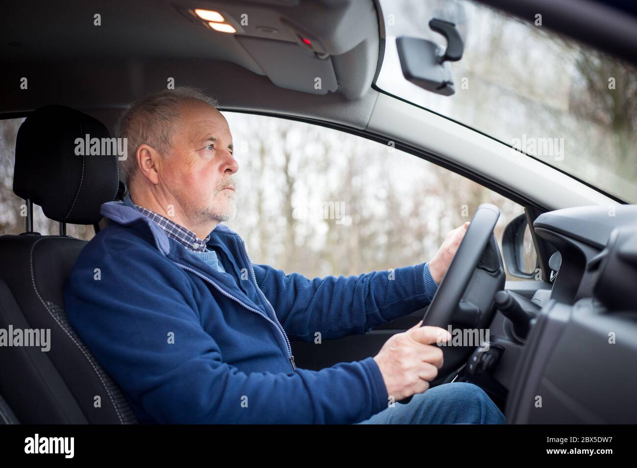 An old senior man driving a modern car, transportation concept Stock ...
