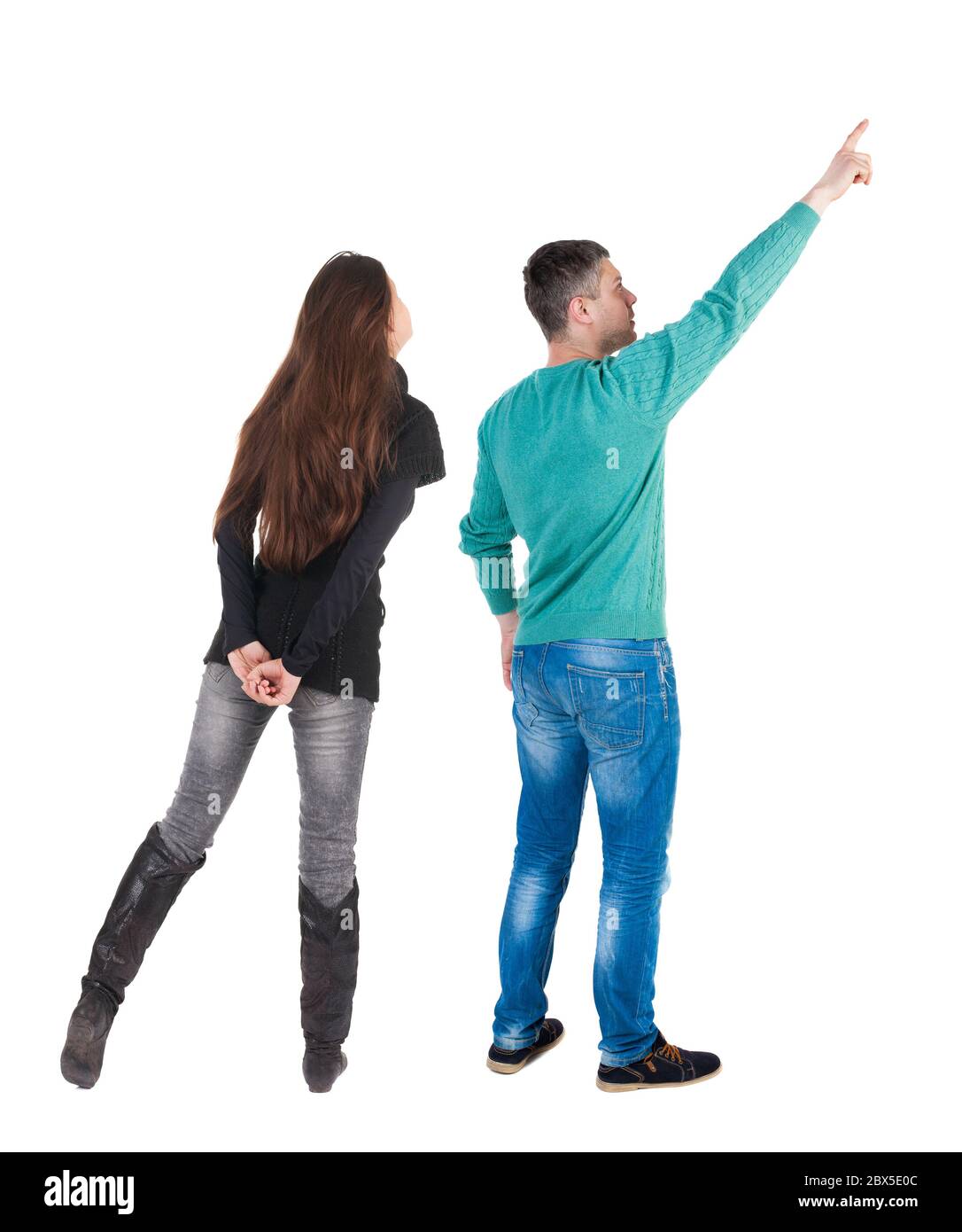 Back view of couple in sweater pointing. Rear view people collection ...