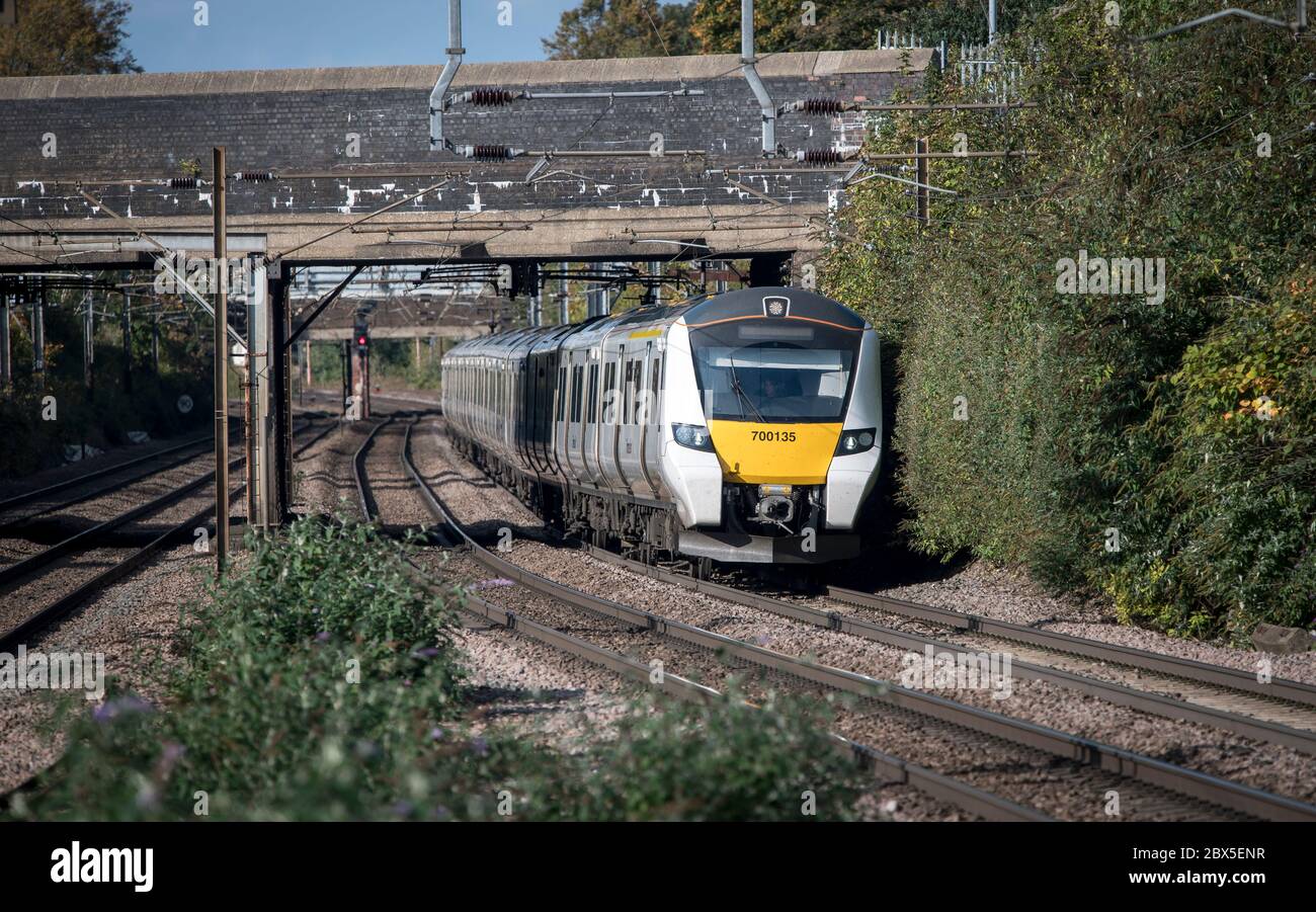 Class 700 passenger train in Thameslink livery travelling in the UK ...