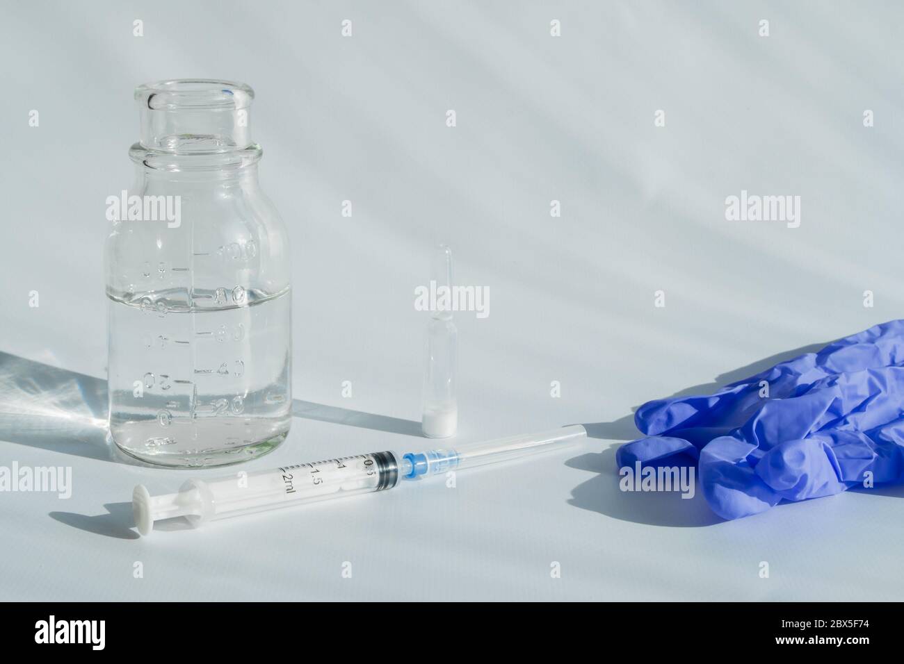 Medical glass bottle with injection. Ampoule with medicine, syringe and ...