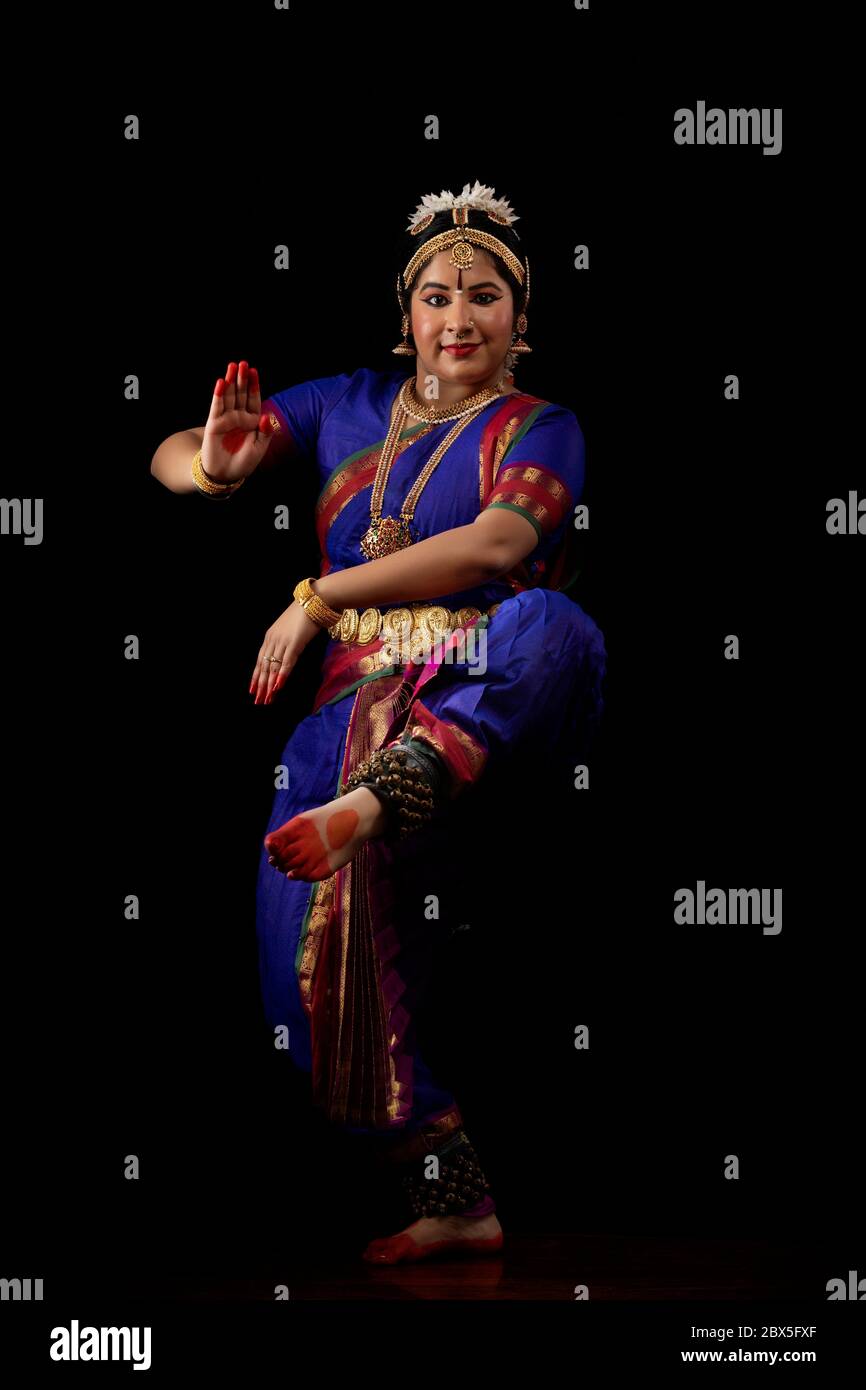Bharatnatyam dancer standing in a natraj pose during her performance ...